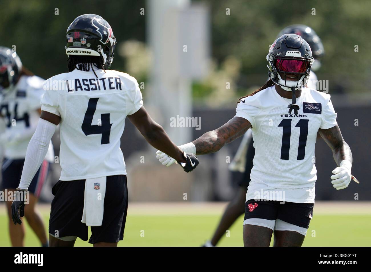 Houston Texans cornerback Kamari Lassiter (4) greets cornerback Tremon ...