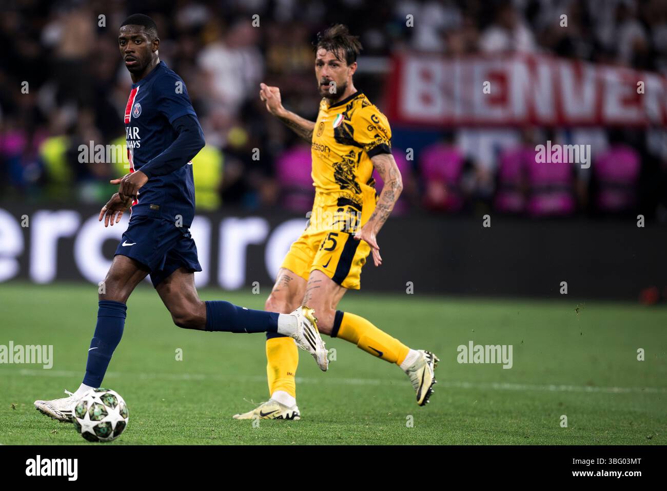Desire Doue of Paris Saint-Germain is challenged by Francesco Acerbi of ...