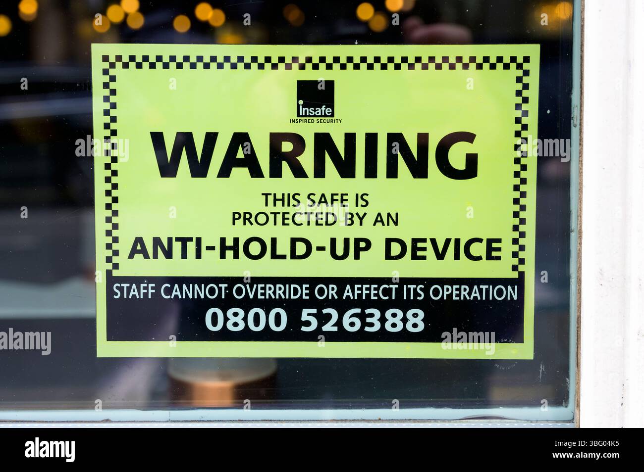 Insafe Anti-Hold Up Device warning sign in a shop window, UK, Europe ...