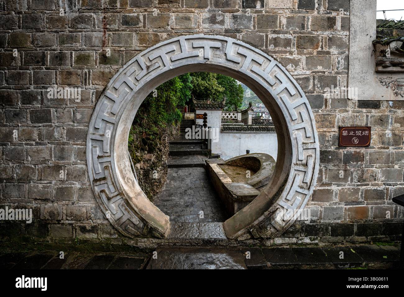 A decorated circular gate connects two courtyards of the temple complex ...