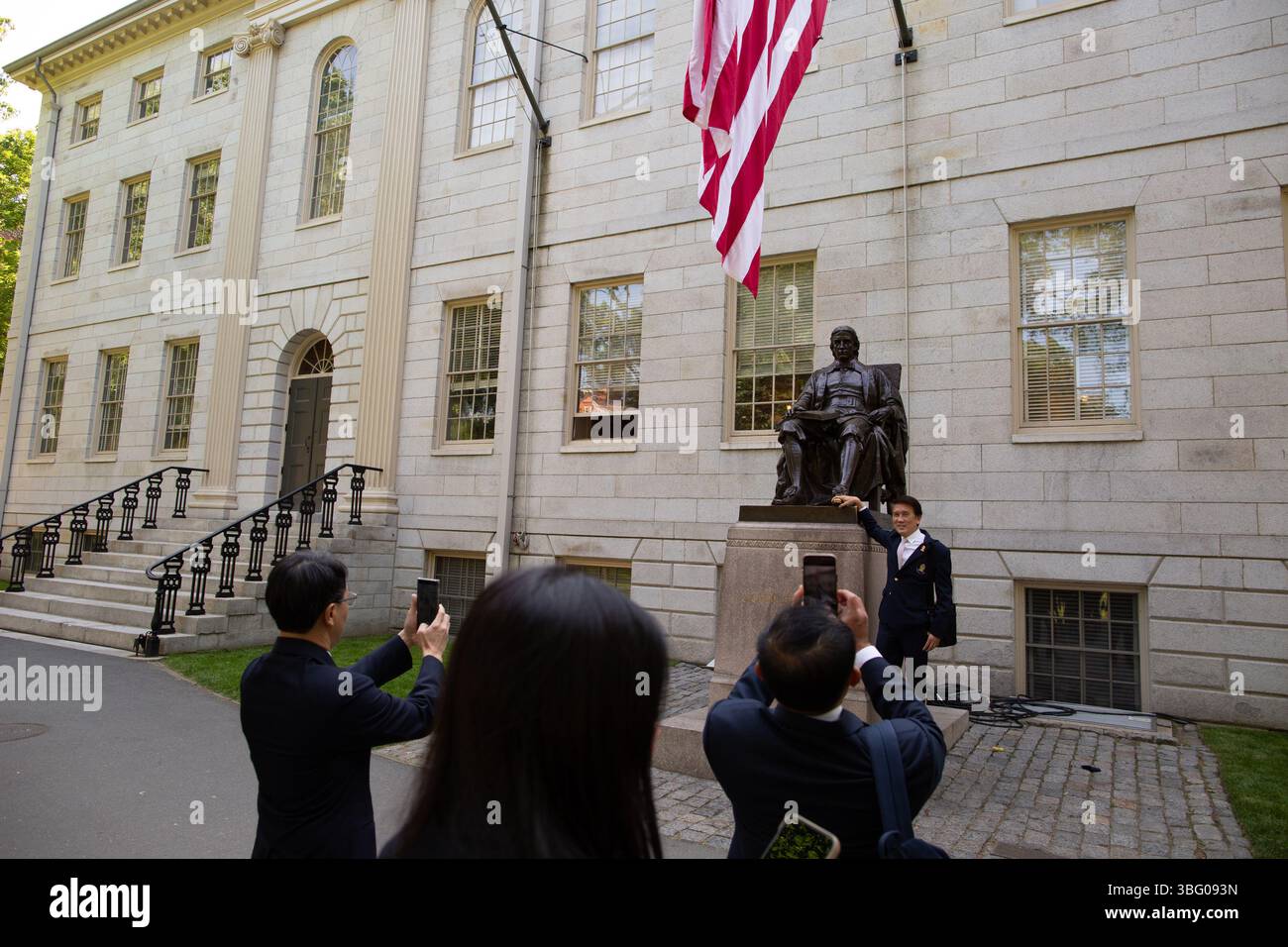 Boston, USA. 03rd June, 2025. Visitors at the John Harvard statue on ...