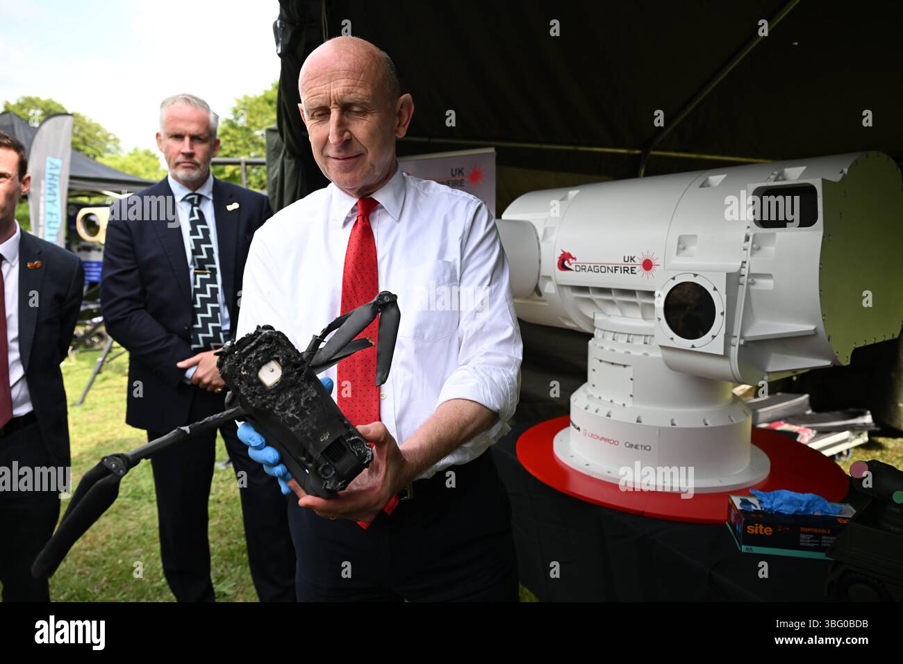 Defence Secretary John Healey holds a domestic drone destroyed as it ...