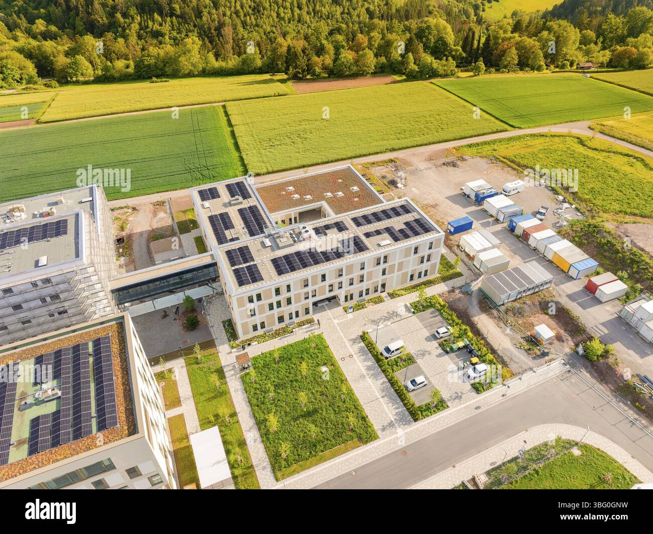 Building with solar roofs and containers in a rural area near a forest ...