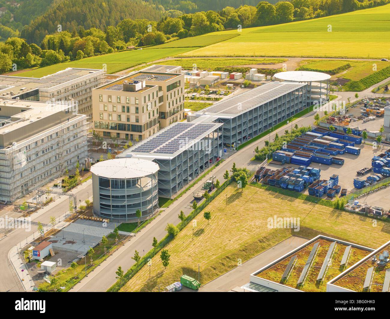 Modern buildings with solar panels in a hilly landscape, taken from a ...