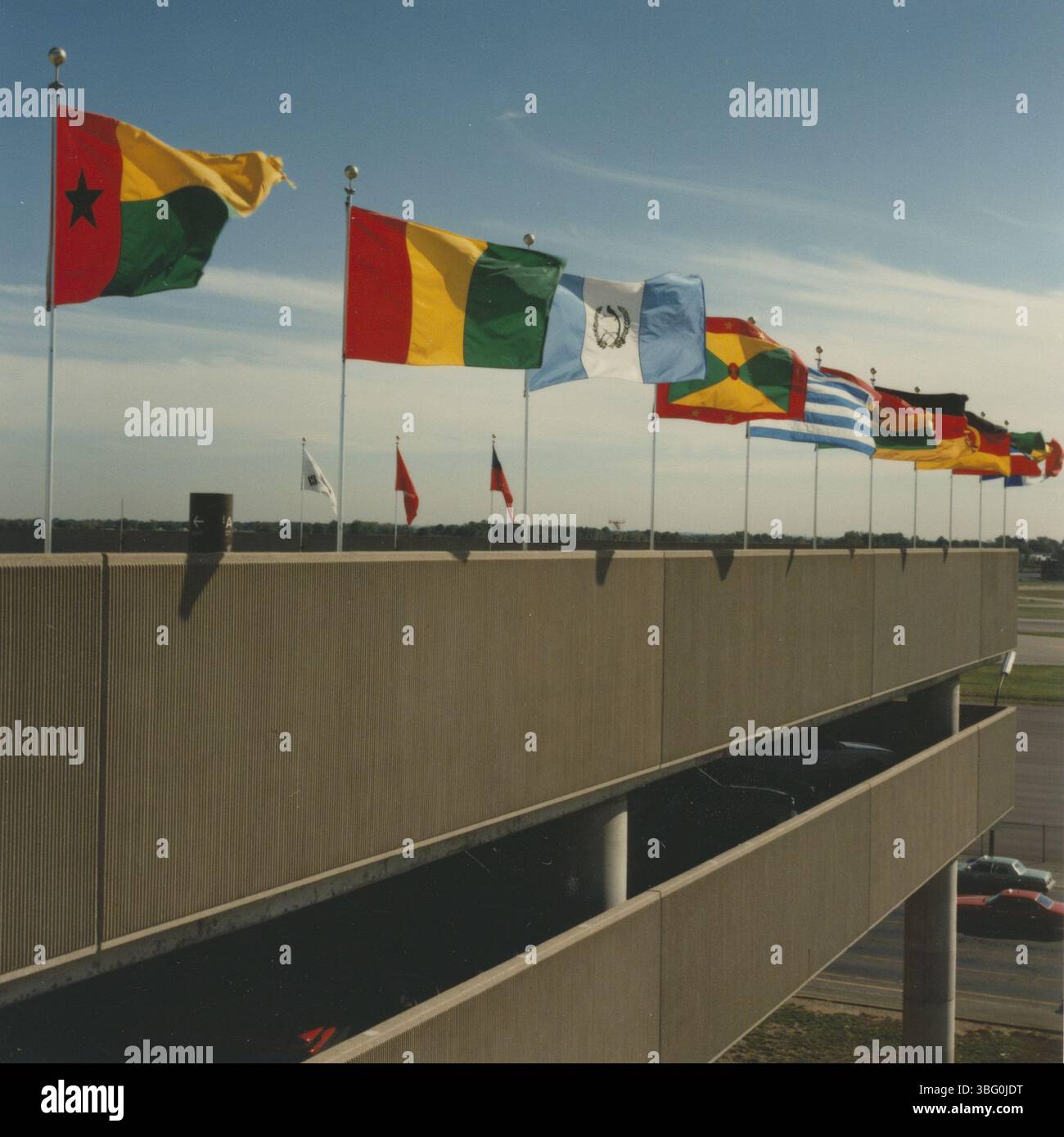 This 1990s photograph features international flags flying from Port ...