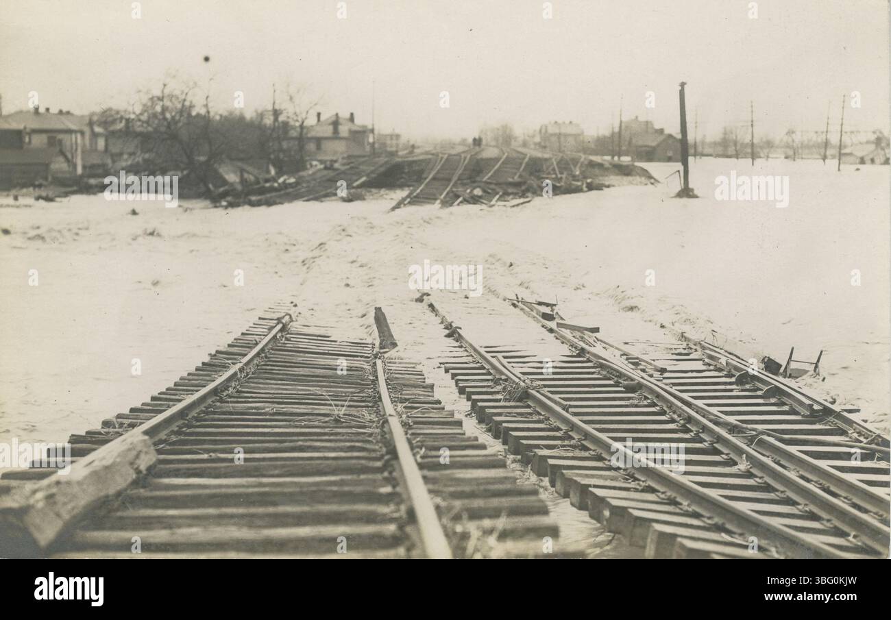 This image shows floodwater spilling over the railroad tracks in ...