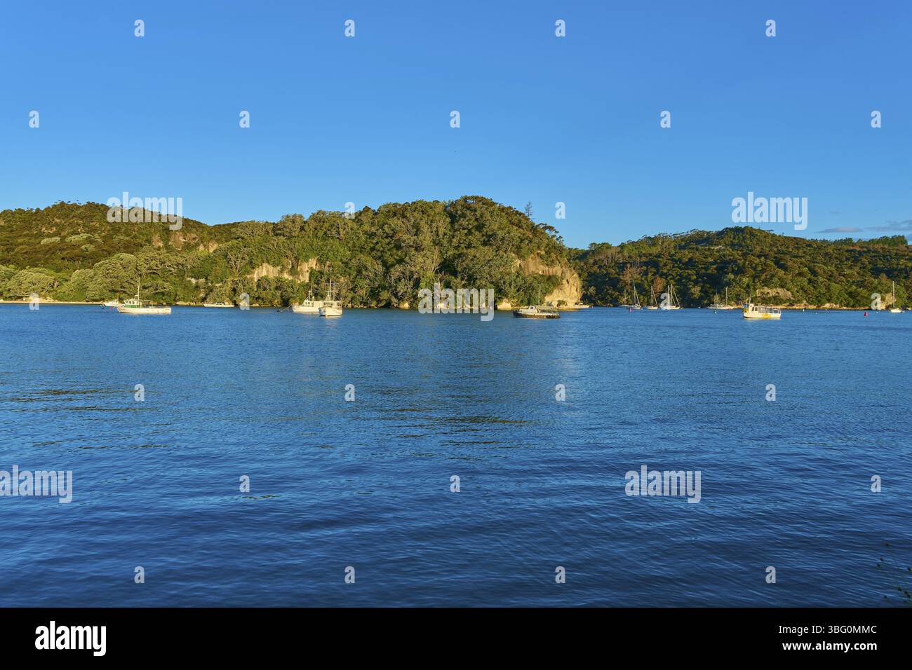 Idyllic landscape with a quiet bay surrounded by forests and boats ...