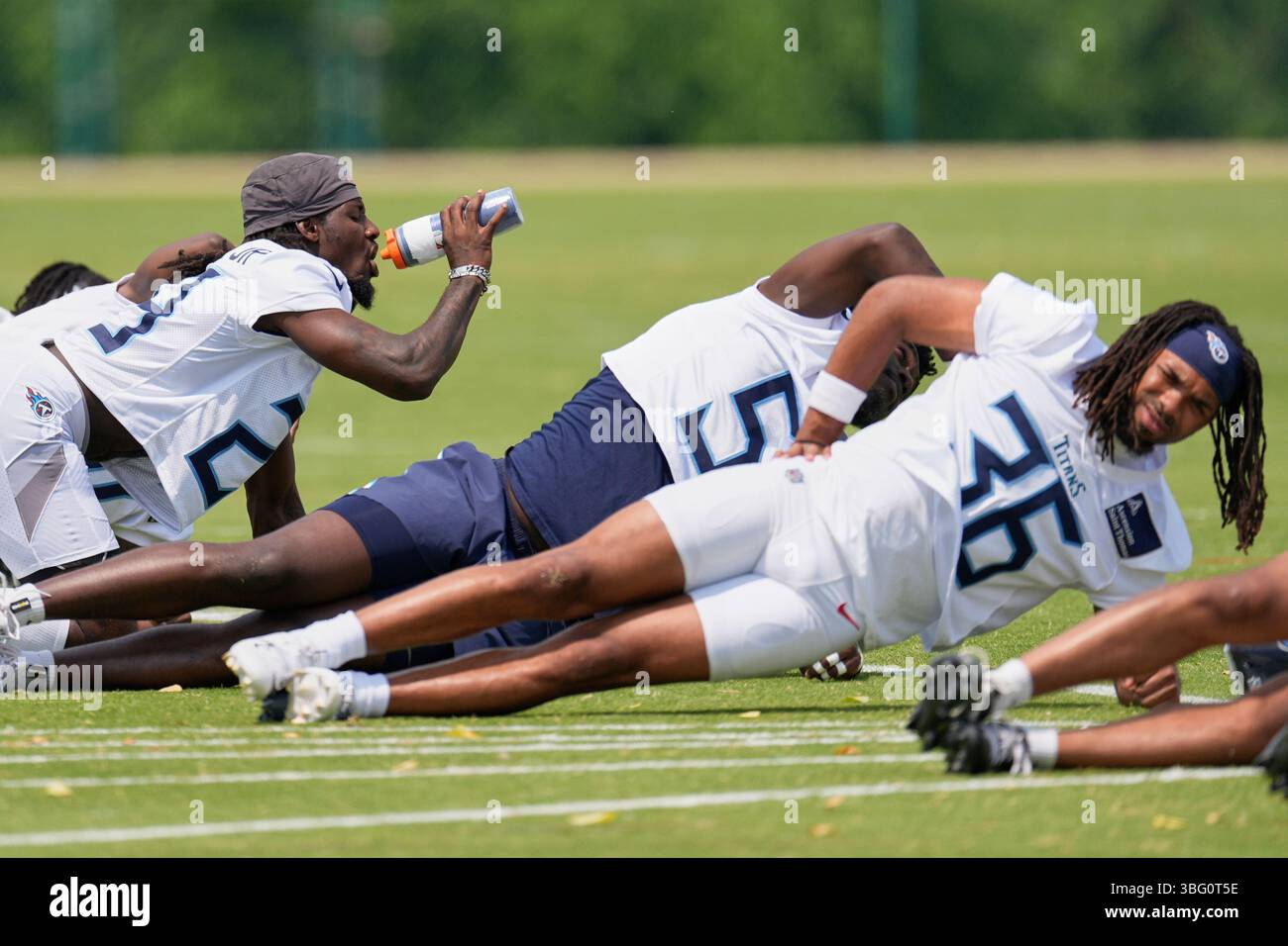 Tennessee Titans cornerback Jarvis Brownlee Jr., left, takes a drink ...