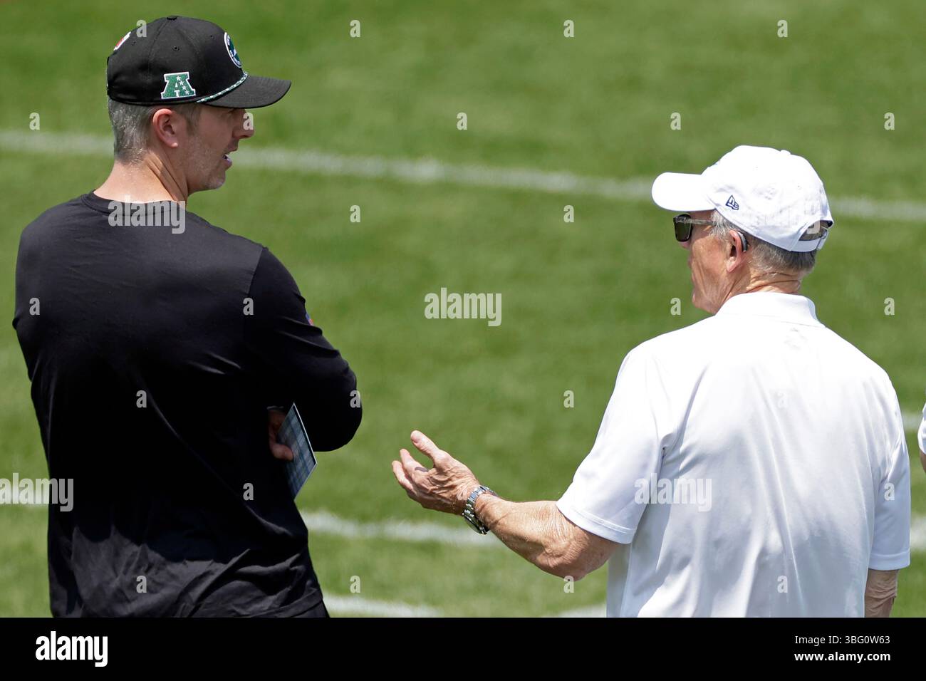 New York Jets general manager Darren Mougey, left, talks to team owner ...