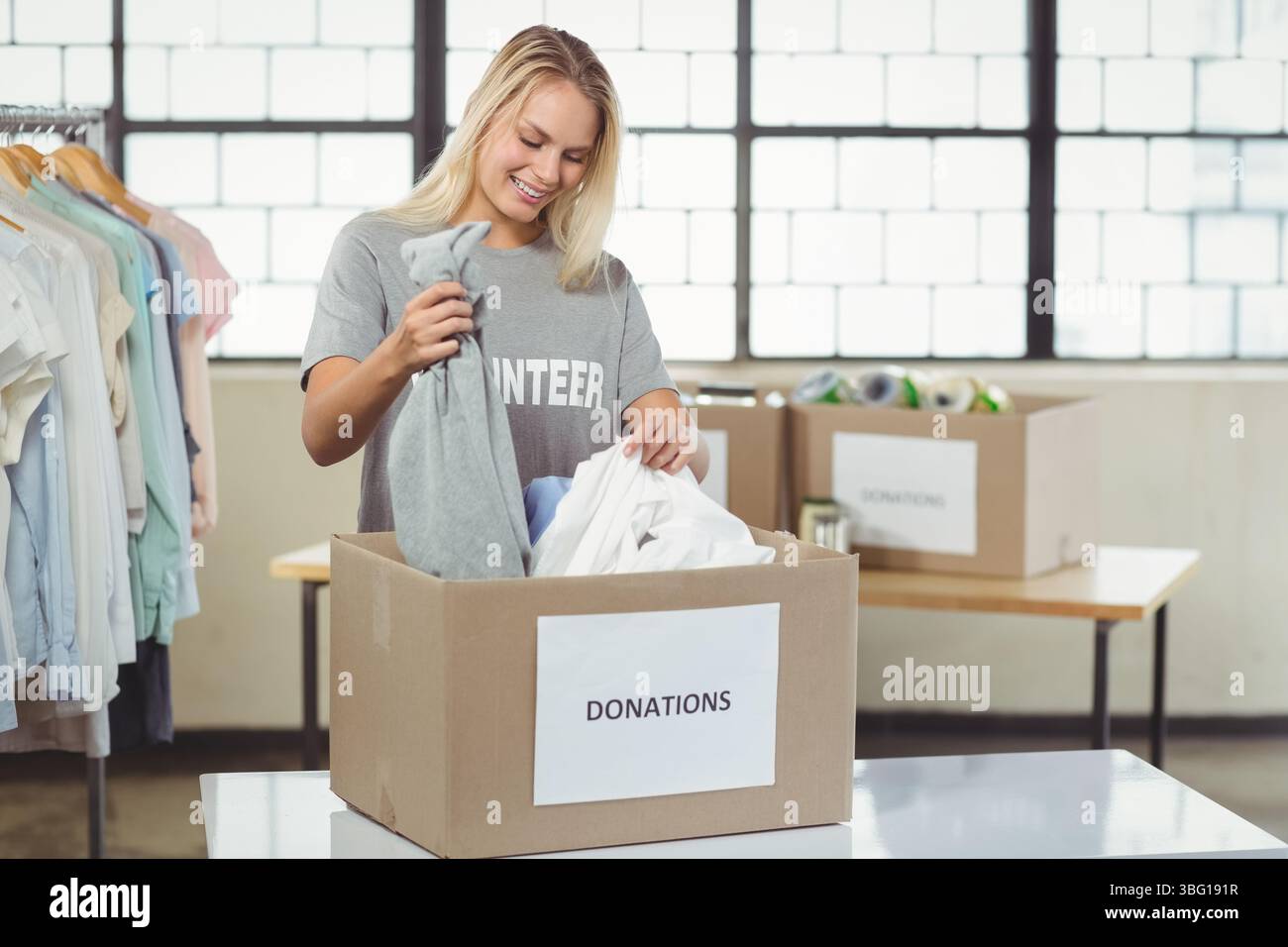 Woman sorting clothes on rack hi-res stock photography and images - Alamy