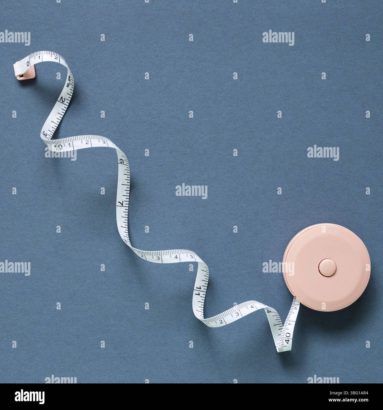 Pink tape measure on navy blue background. top view, copy space Stock ...