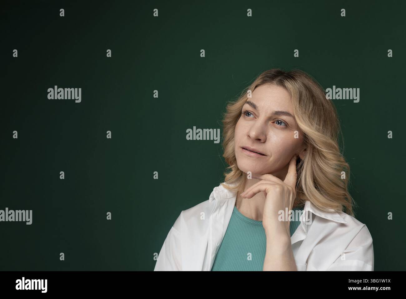 A woman standing in a confident pose, smiling for a picture in front of ...