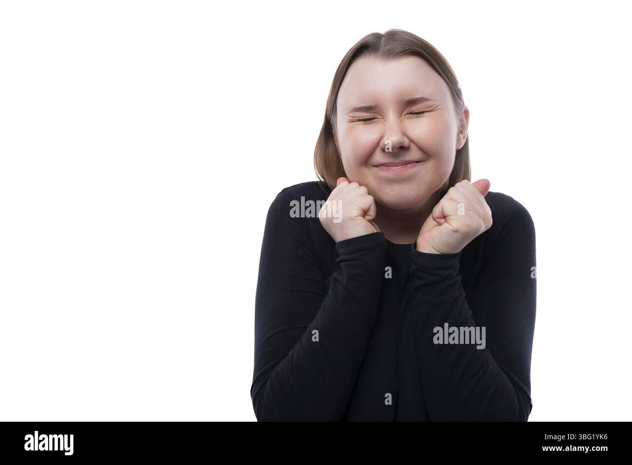 Happy cheerful school age girl dressed in black clothes on a white ...