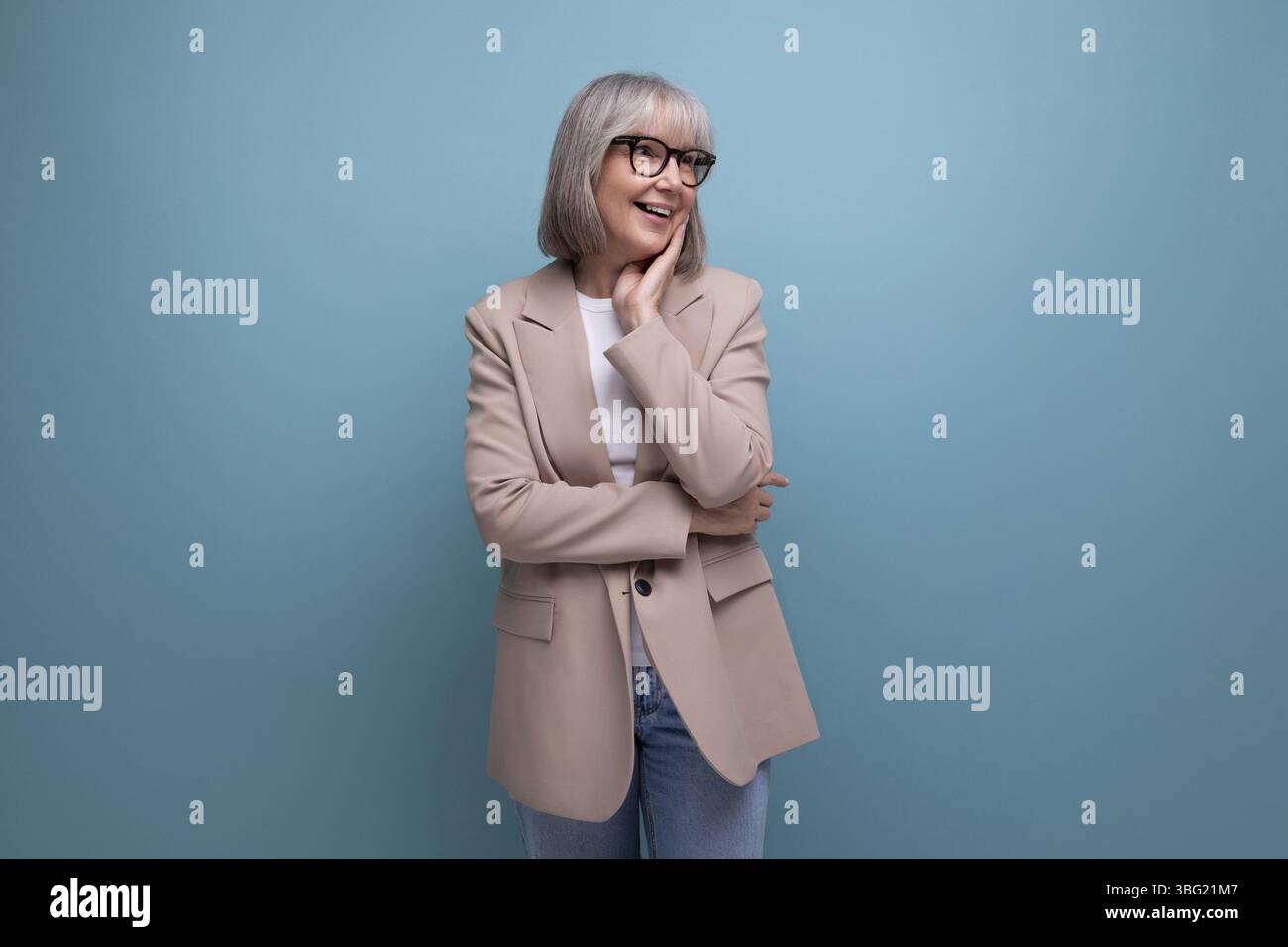 Nice neat business 60s lady in a stylish look on a studio background ...