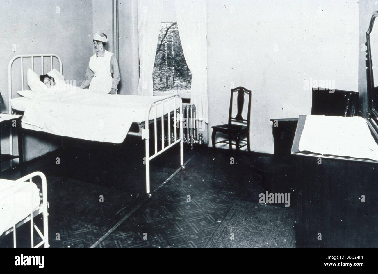 This photograph from 1920 shows a patient and a nurse in a room at ...