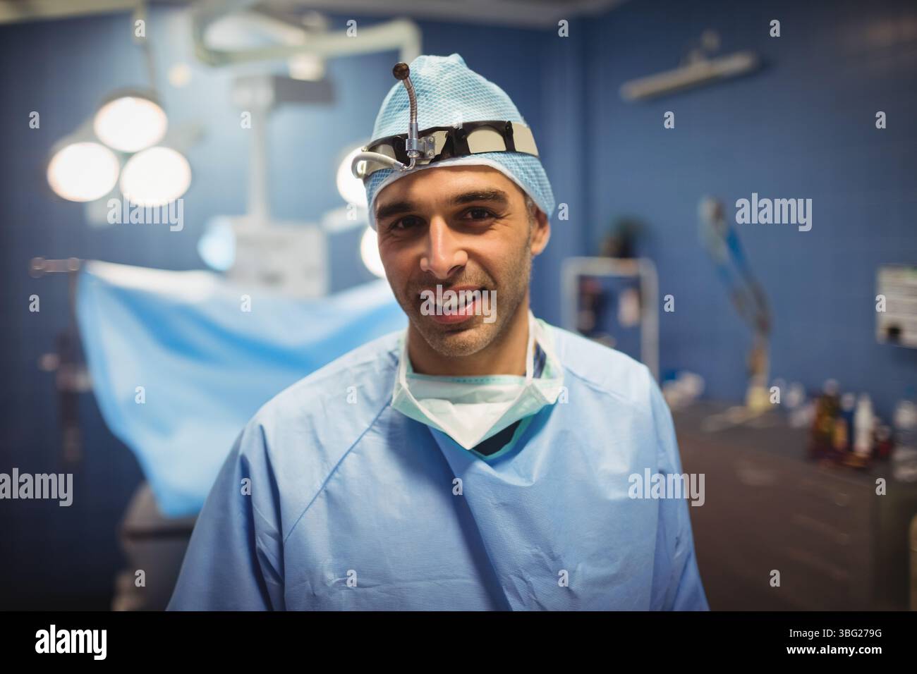 Surgeon wearing headlamp and mask hanging on neck in operating room ...