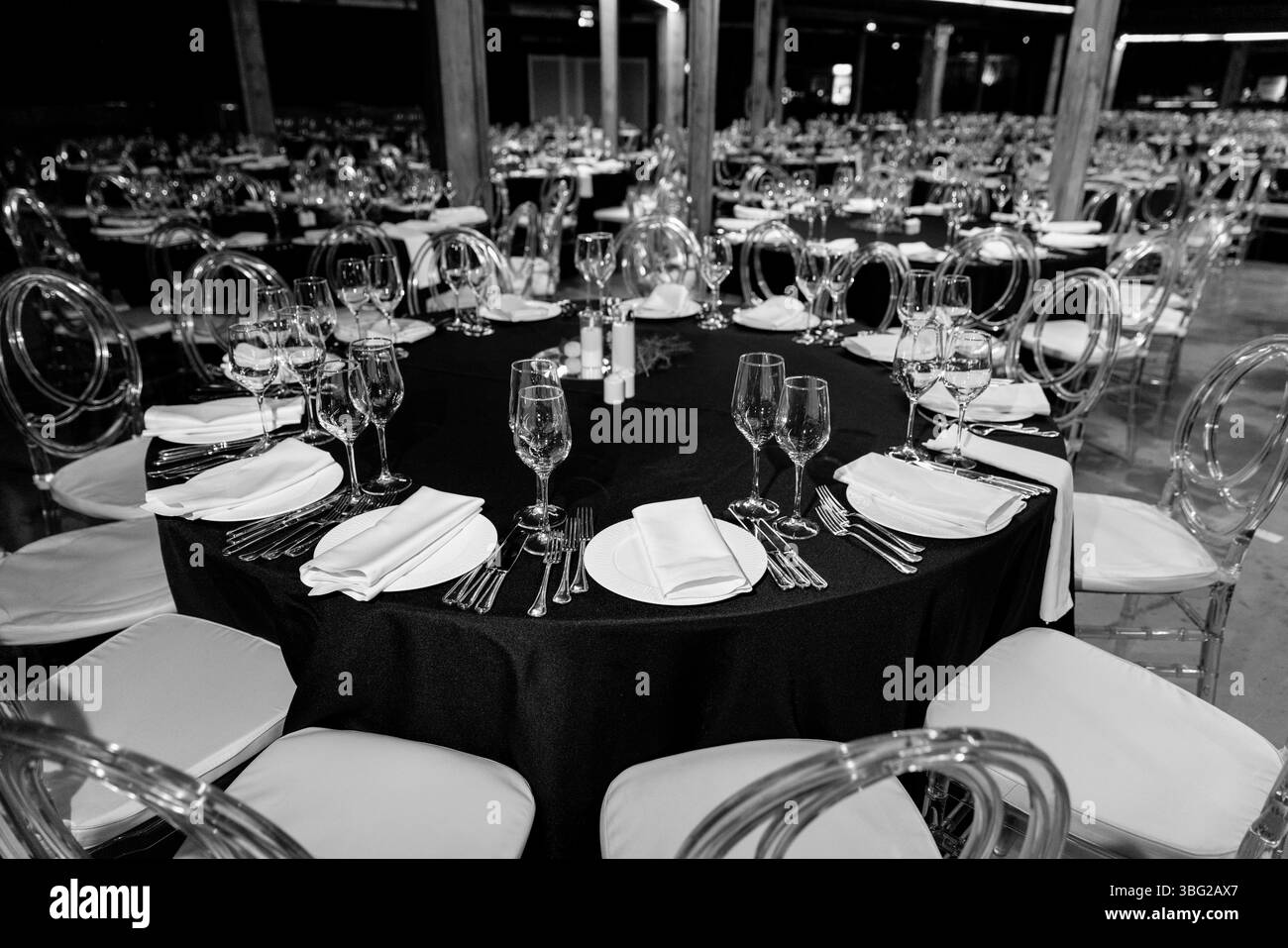 Black and white photo of a stylishly set round black table with elegant ...