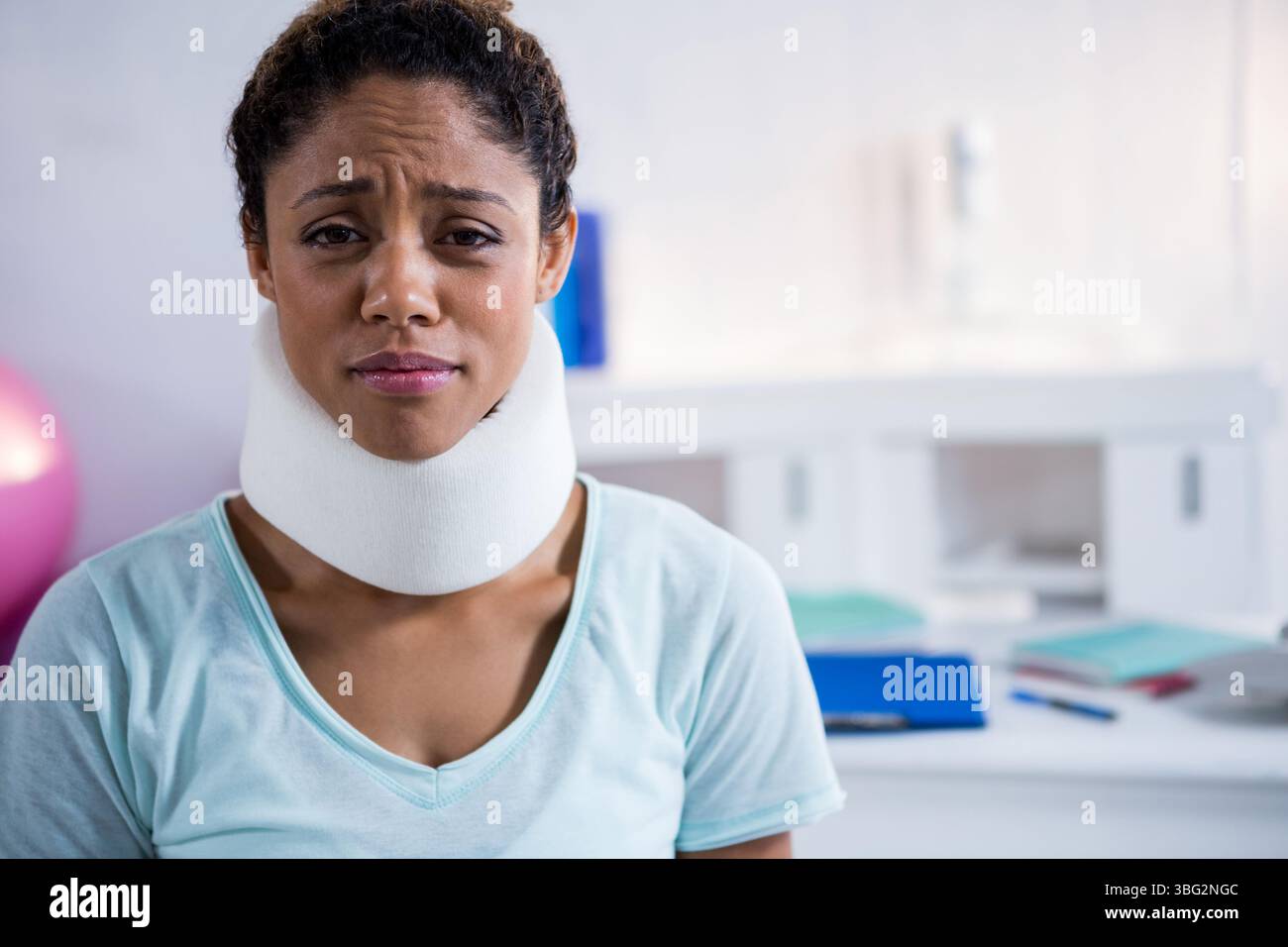 African American woman sitting in therapy room wearing cervical collar ...