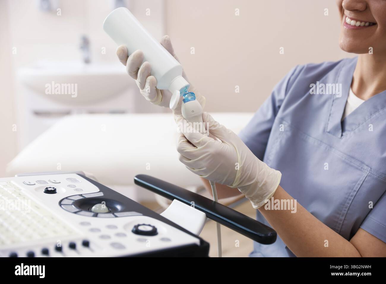 Sonographer applying gel on ultrasound transducer in clinic, closeup ...