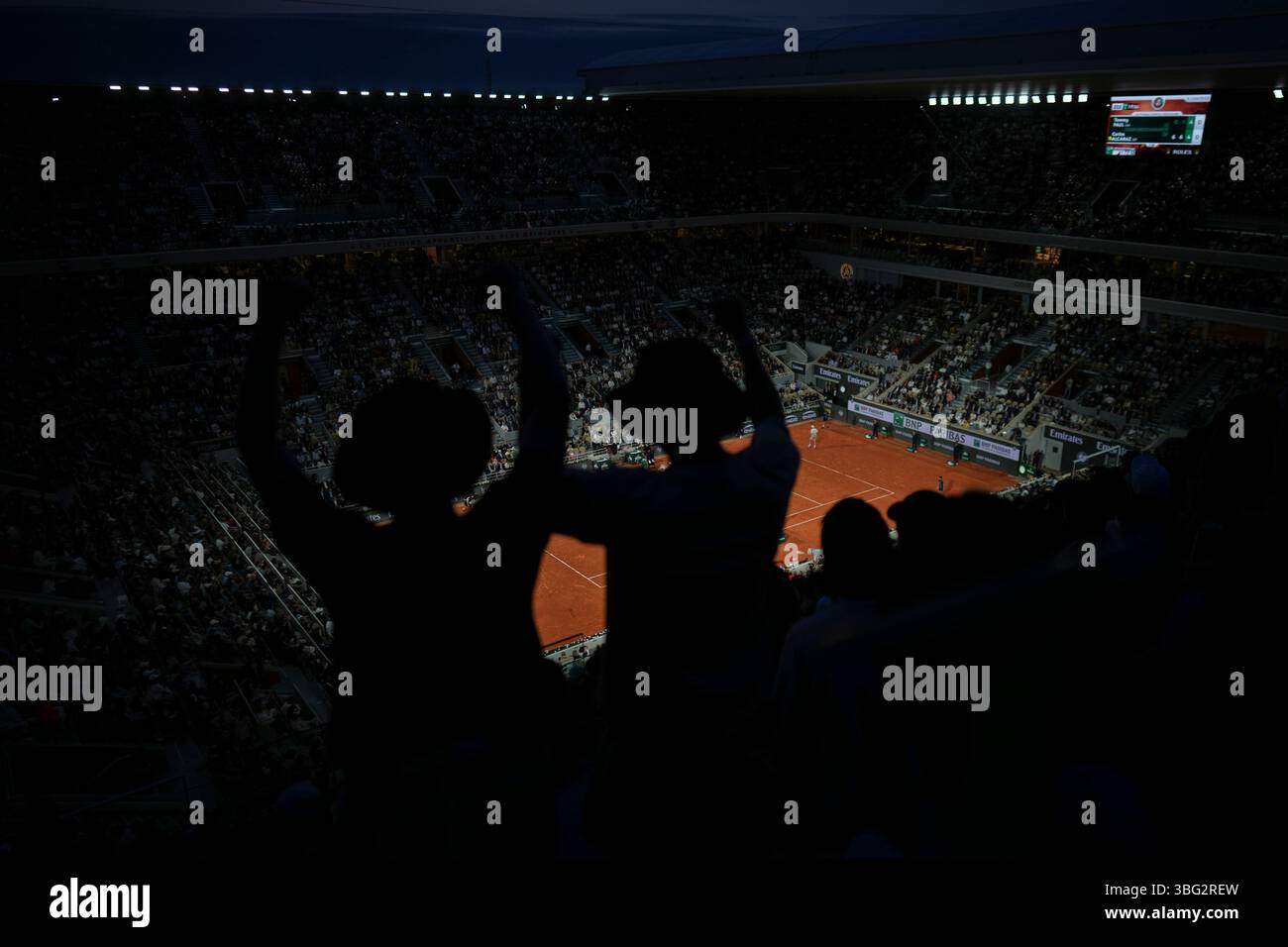 Spectators watch the quarterfinal match of the French Tennis Open ...
