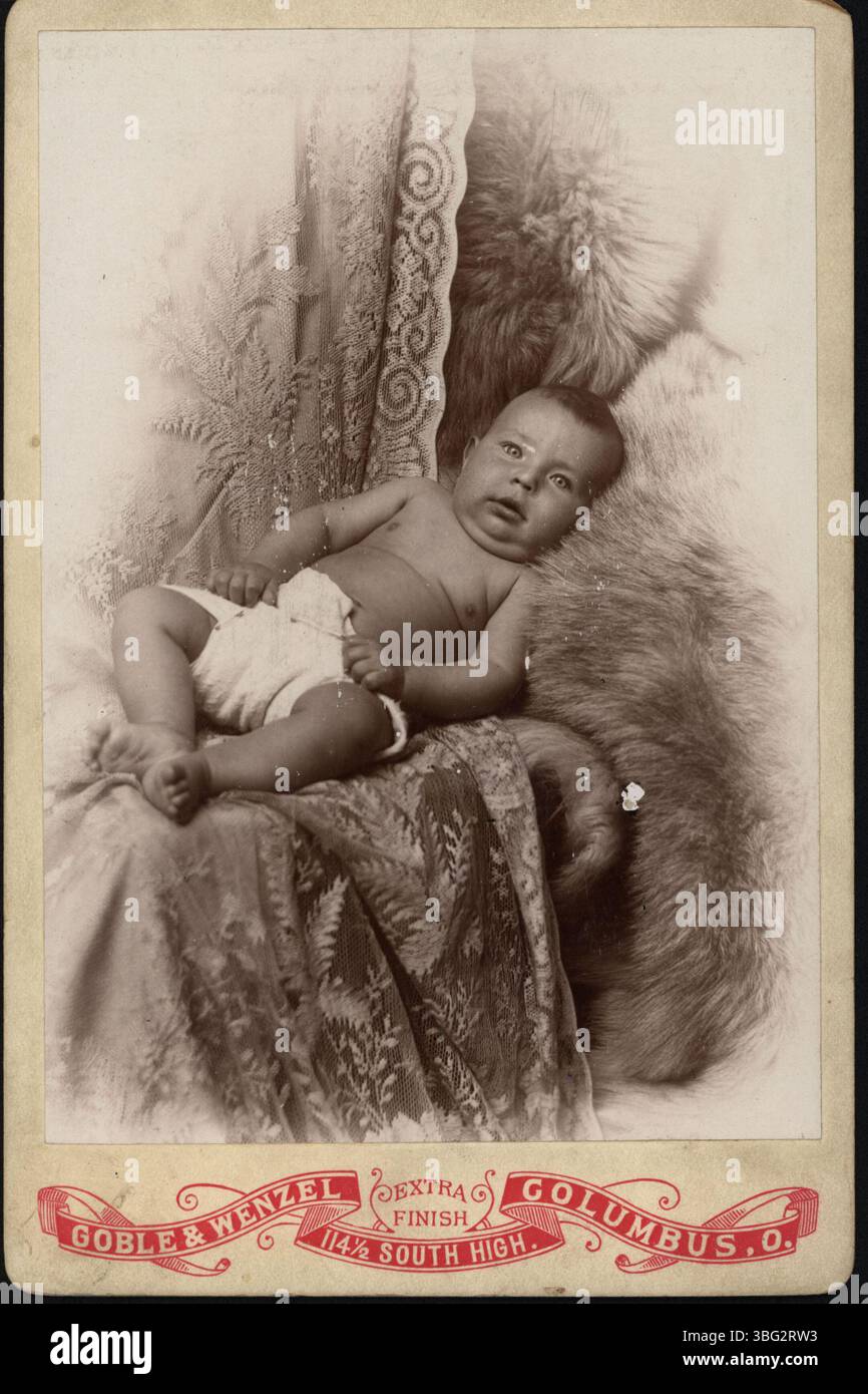 This photograph from 1890-1891 shows an unidentified baby wearing a ...