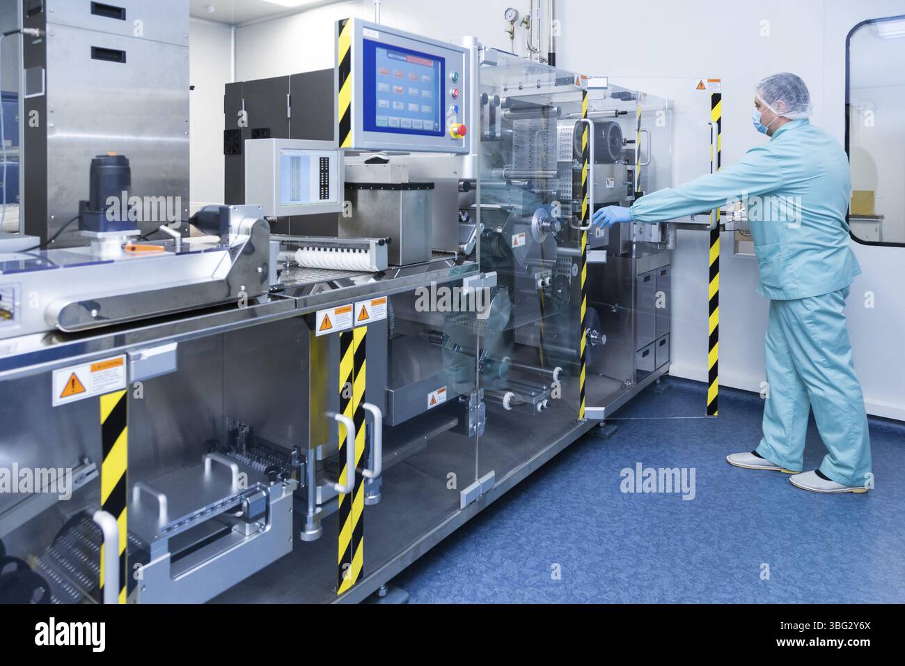 Pharmacy industry factory man worker in protective clothing in sterile ...