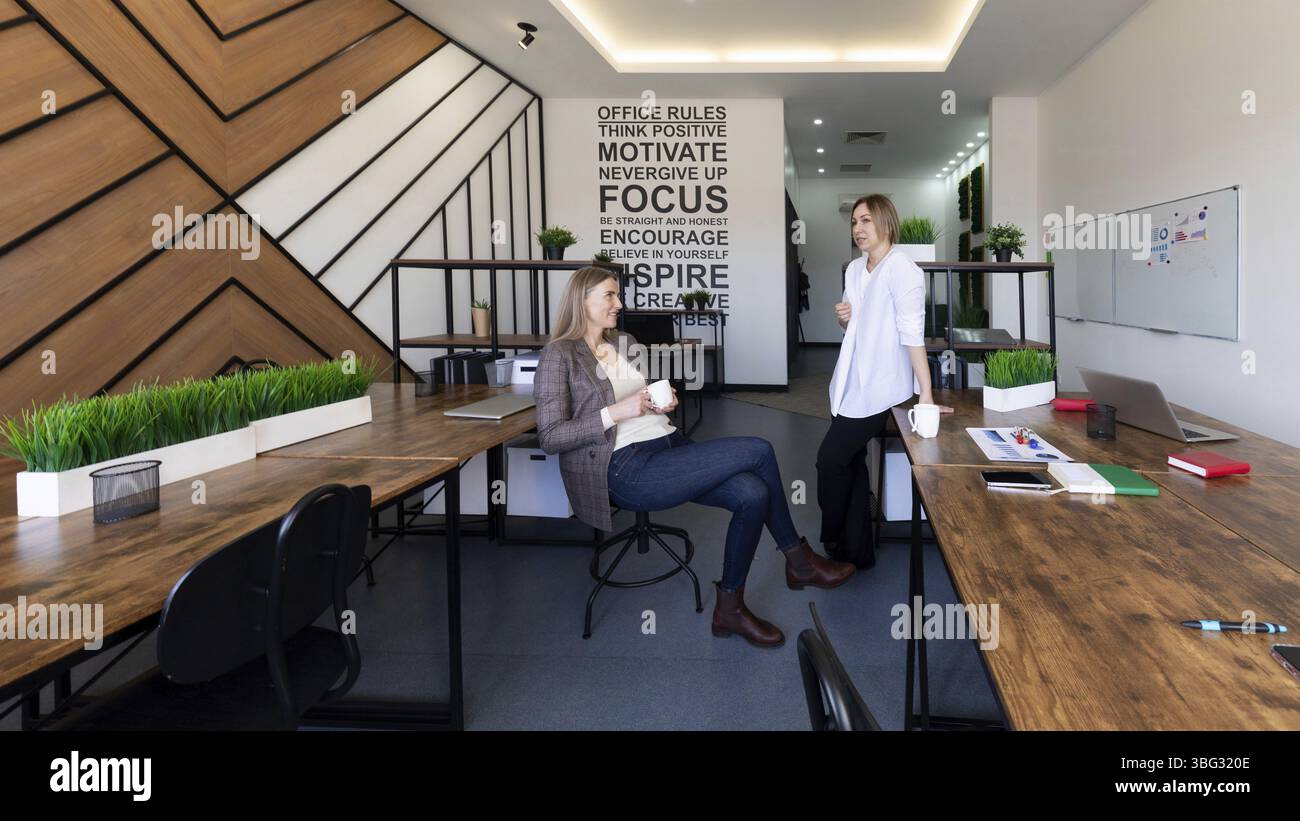 Office colleagues engage in productive hi-res stock photography and ...