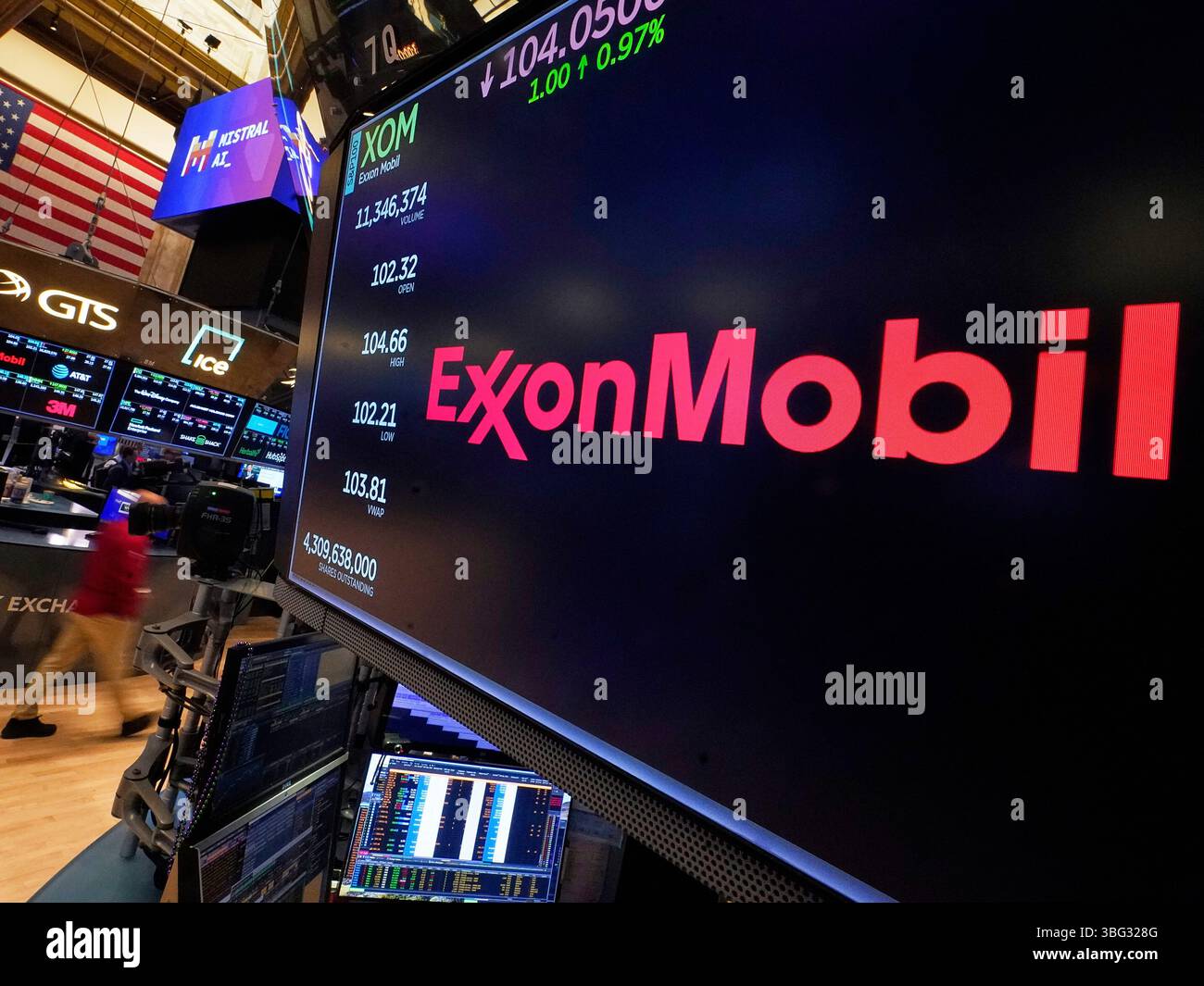 The logo for ExxonMobil is displayed above a trading post on the floor ...