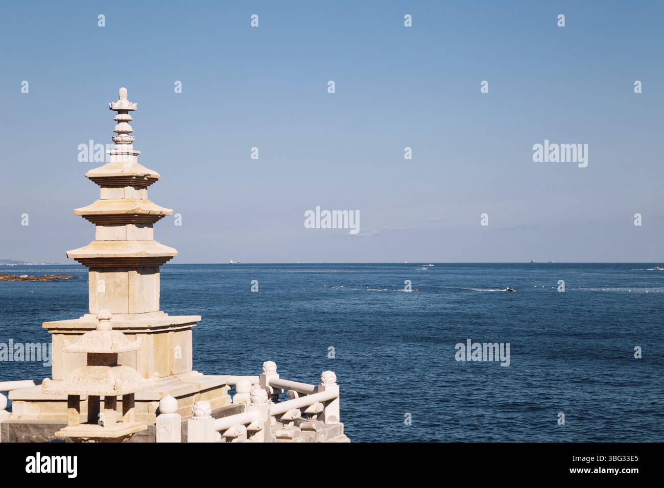 Stone tower with blue ocean at Haedong Yonggungsa Temple in Busan ...