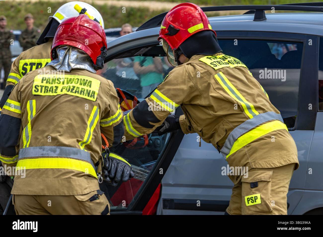Firefighters pull a man trapped in a car after a car accident, rescue ...
