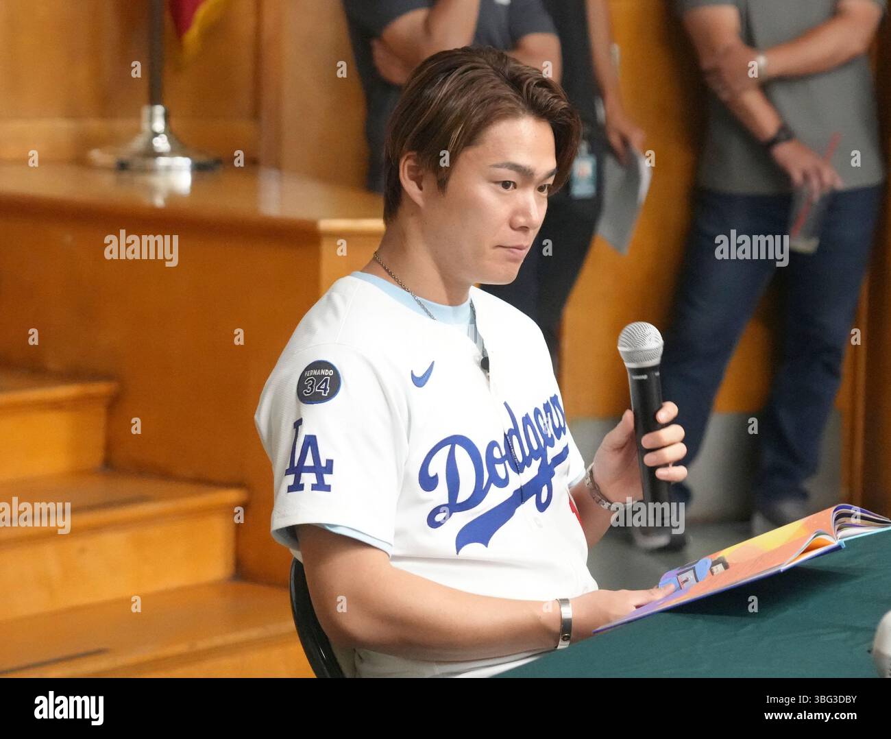Los Angeles Dodgers pitcher Yoshinobu Yamamoto reads a book in Japanese ...