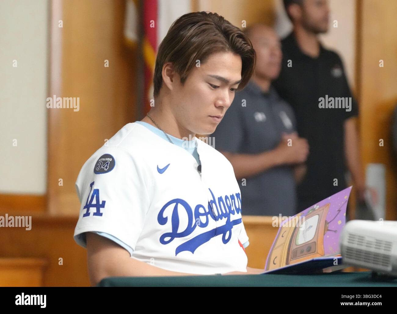 Los Angeles Dodgers pitcher Yoshinobu Yamamoto reads a book in Japanese ...