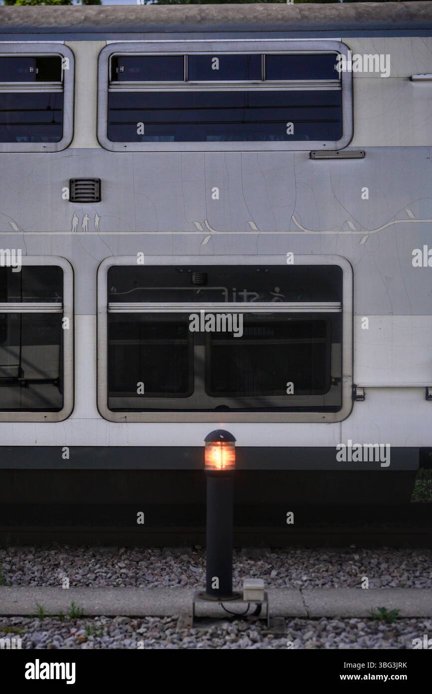Close-up vertical shot of a glowing bollard light in front of a French ...
