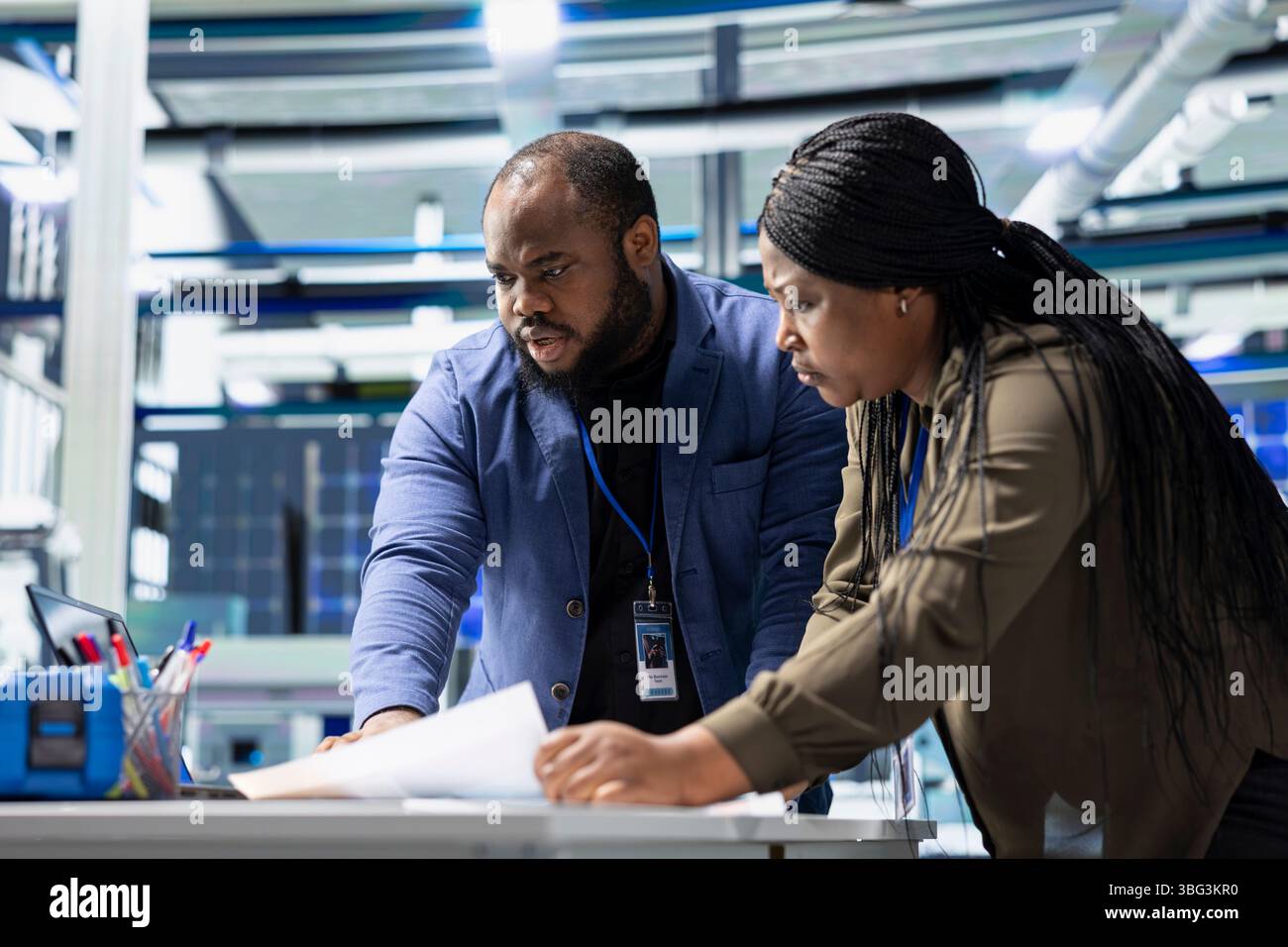 Black team of engineers technicians share ideas in a solar panel ...