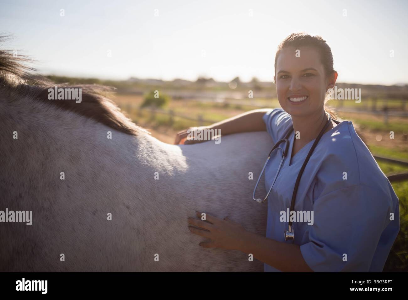 Female veterinarian standing beside horse at ranch with stethoscope by ...