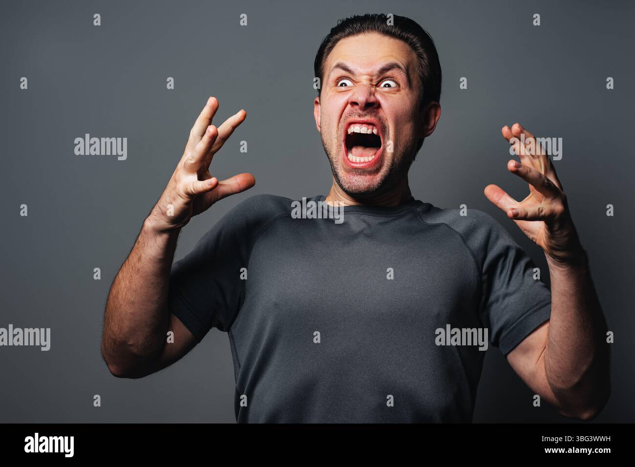 Angry man emotional aggressive portrait on gray background Stock Photo ...