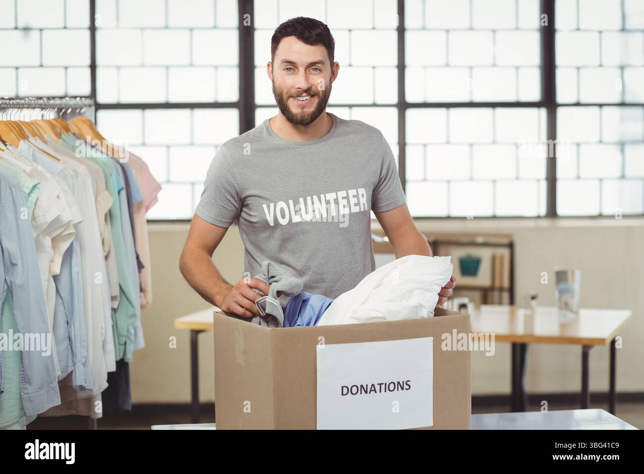 Focused man volunteering donation center hi-res stock photography and ...