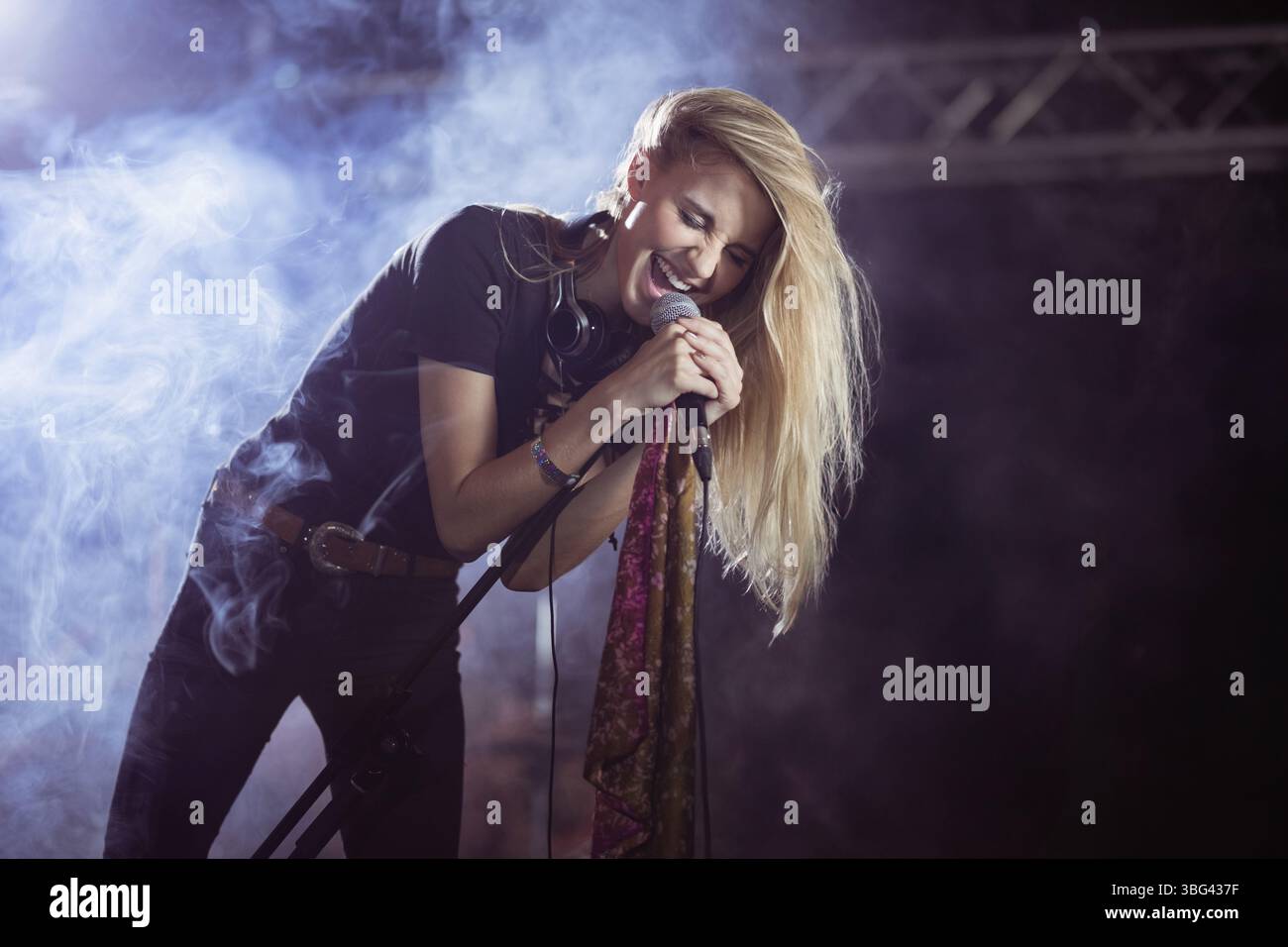 Female singer gripping microphone music hi-res stock photography and ...