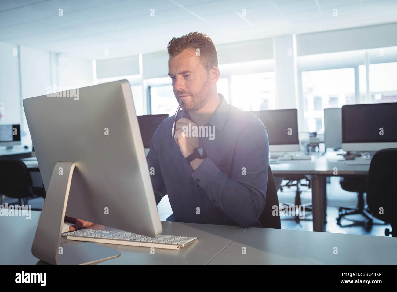 Modern office desk hosting desktop computer and wireless keyboard in ...