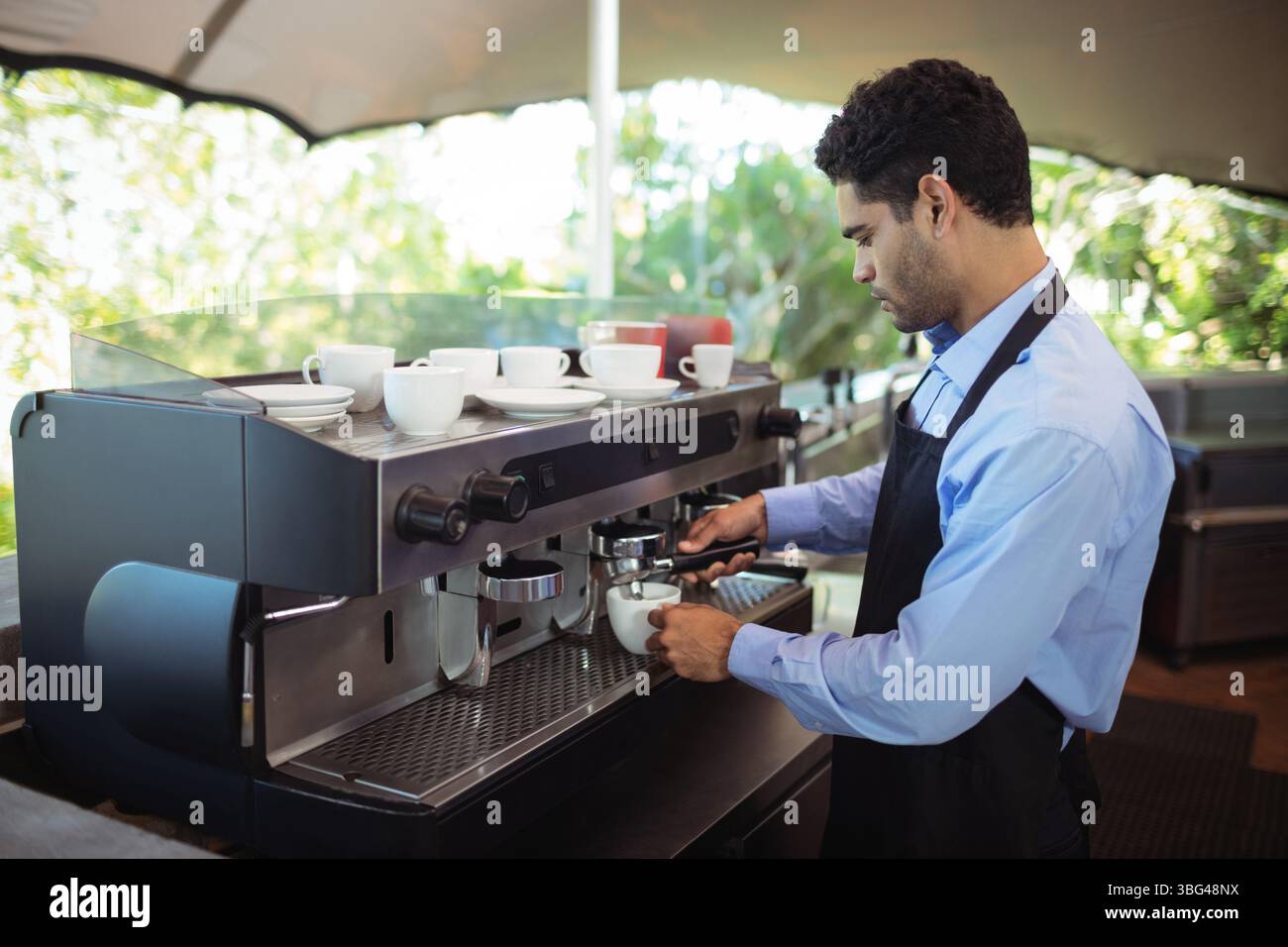 Barista operating commercial espresso machine hi-res stock photography ...