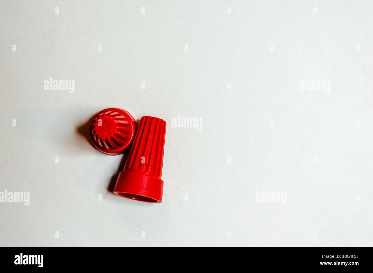Two red wire twist connectors on a white background Stock Photo - Alamy