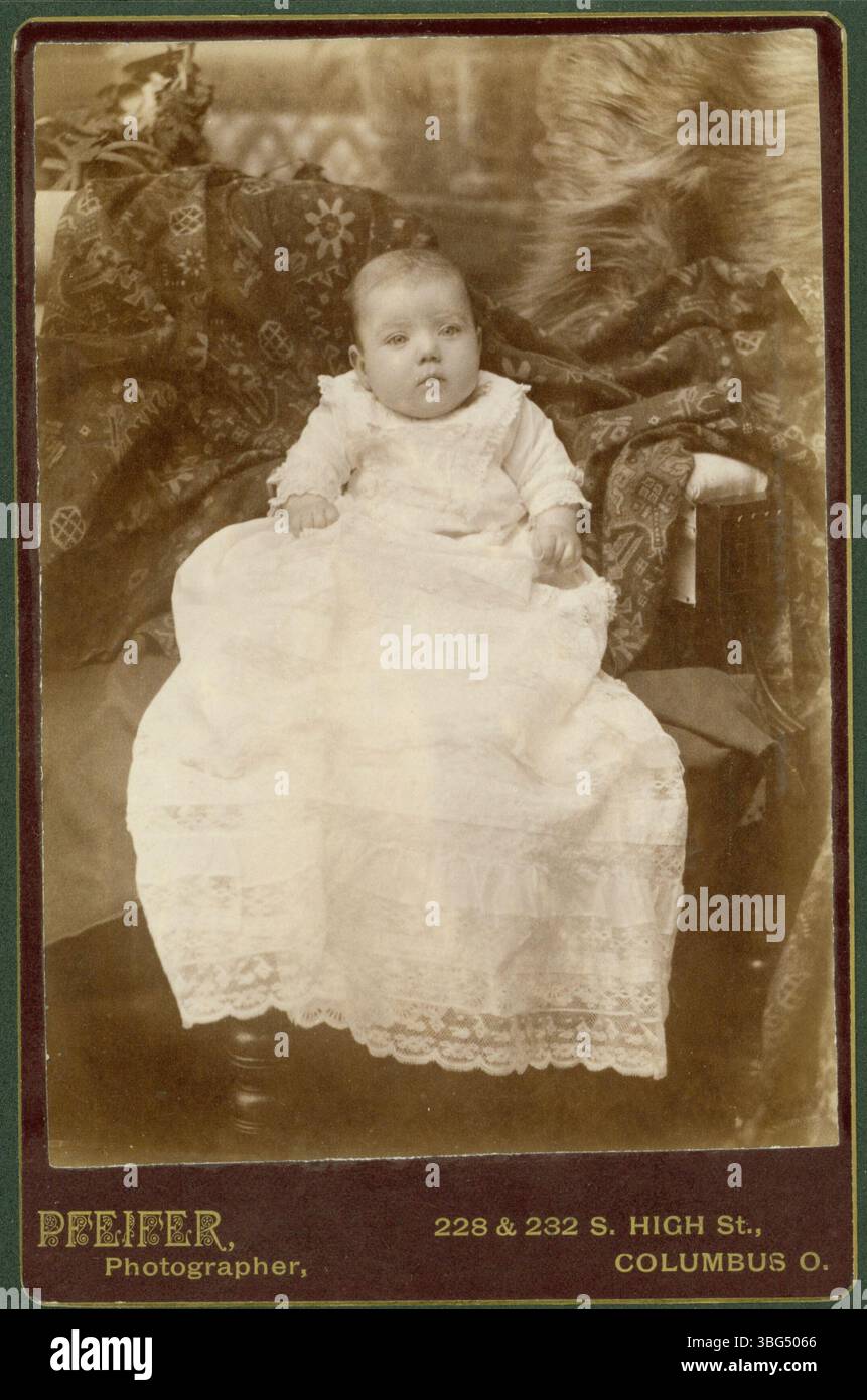 A photograph of an unidentified baby wearing a long white gown, taken ...
