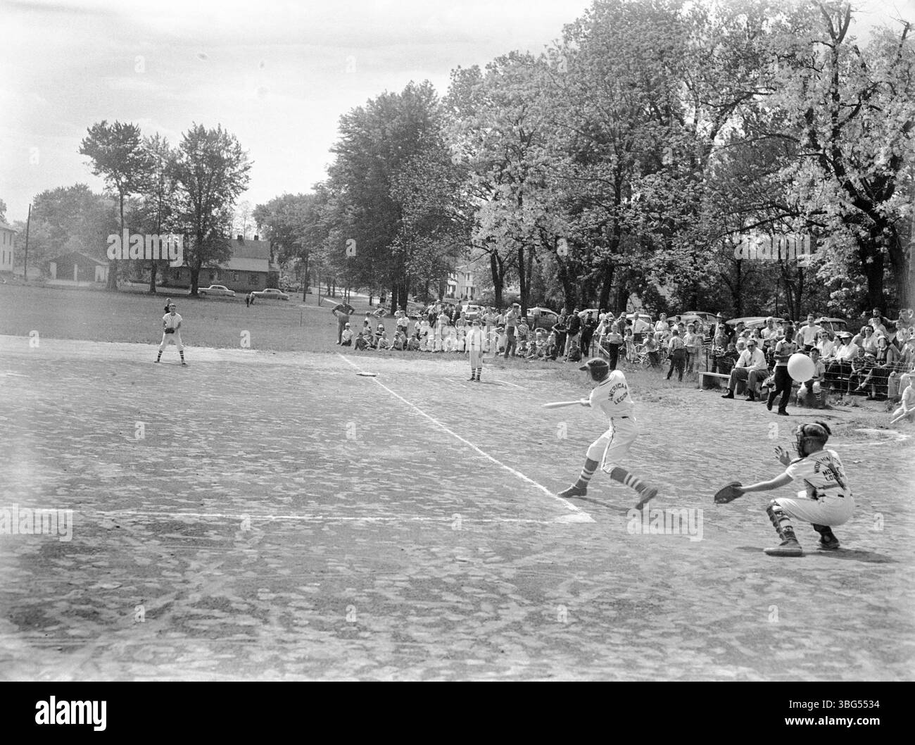 This photograph from circa 1955 shows a Little League baseball game in ...