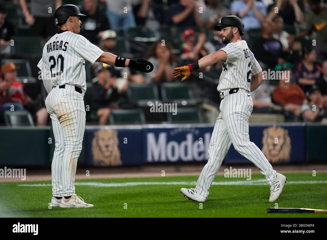 Chicago White Sox's Miguel Vargas (20), left, and Andrew Benintendi (23 ...