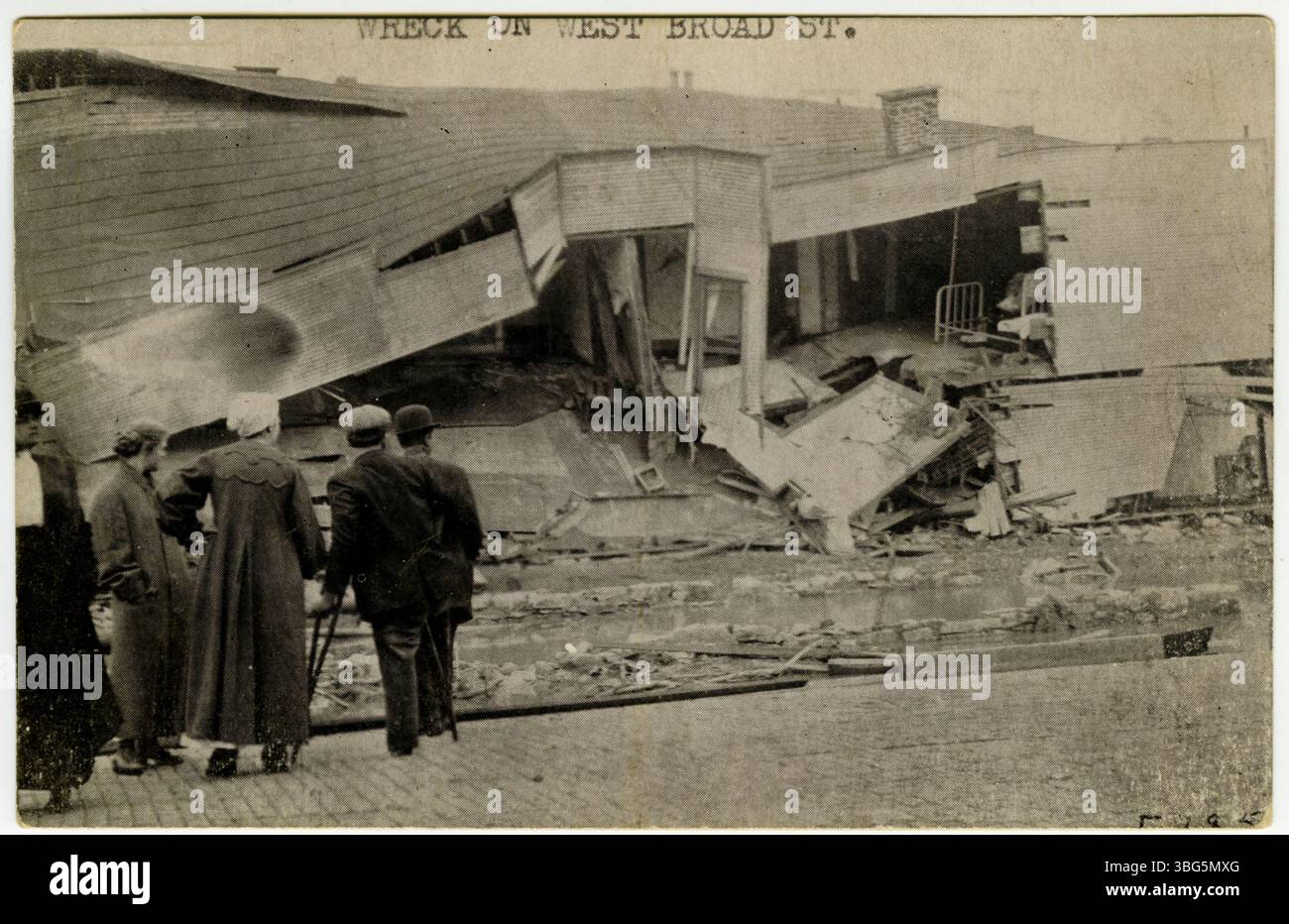 This black-and-white photographic postcard from the 1913 flood shows a ...