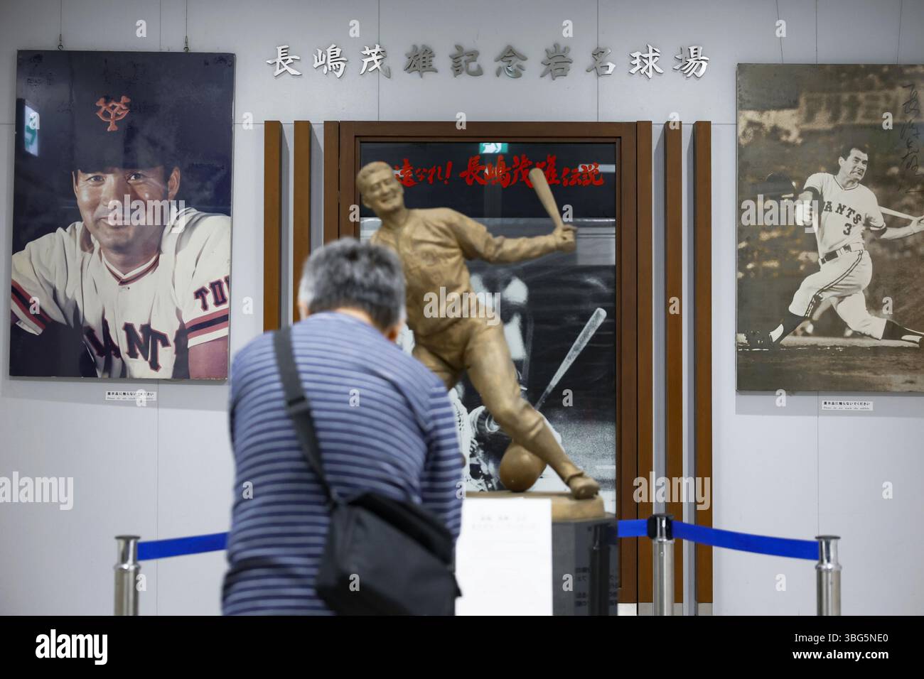 A man signs a condolence book at a baseball stadium in Sakura, the ...