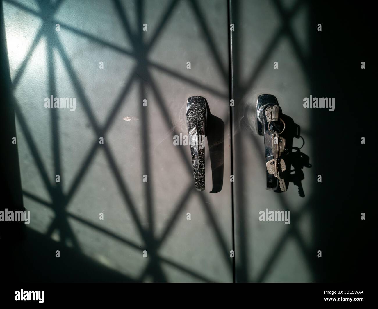 Artistic view of metal cabinet handles casting shadows on a surface ...