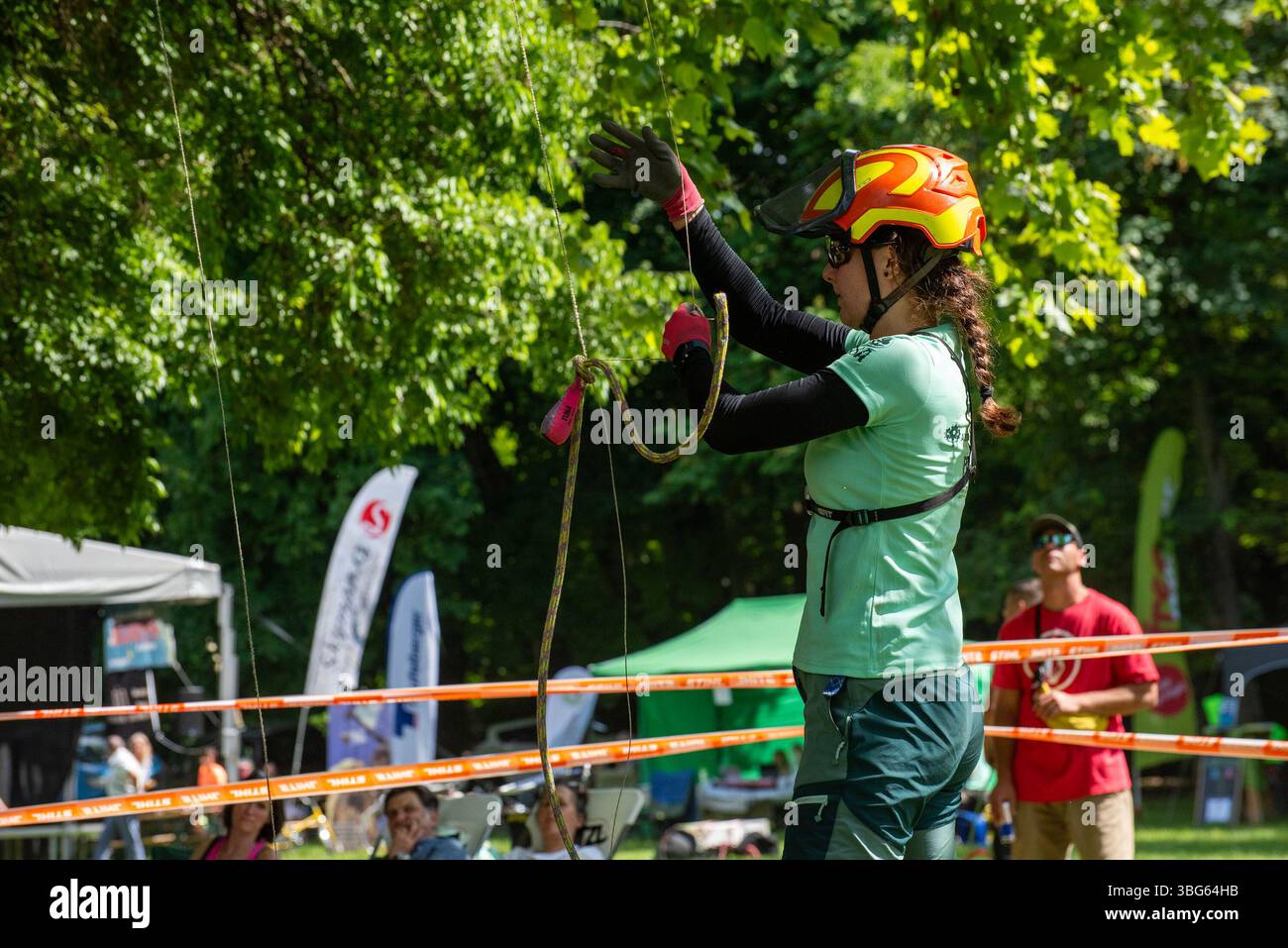 Tata, Hungary. 31st May, 2025. The female athlete pulls up her rope to install it on the tree ...