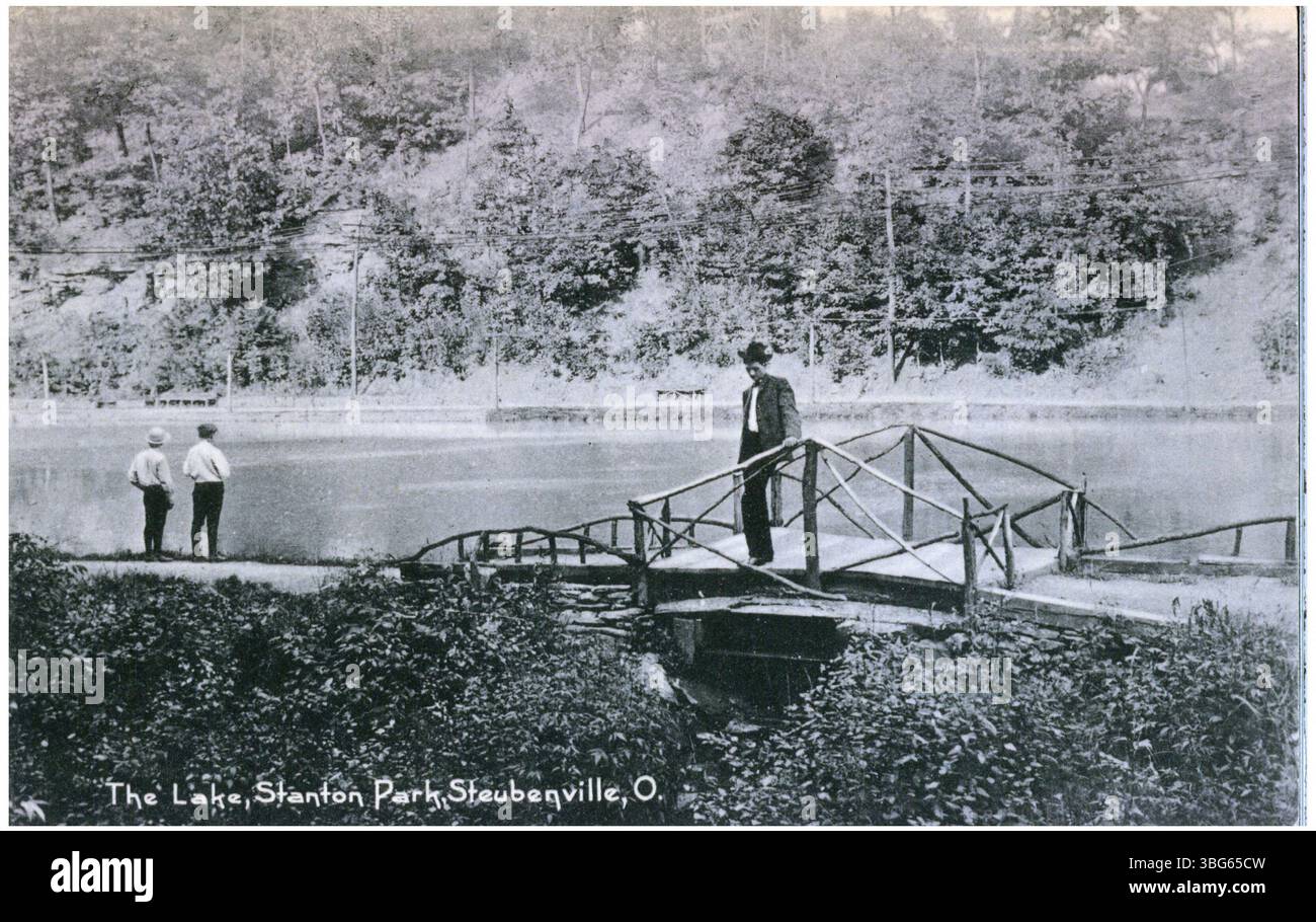 A black and white photograph from 1906 showing a small wooden bridge ...