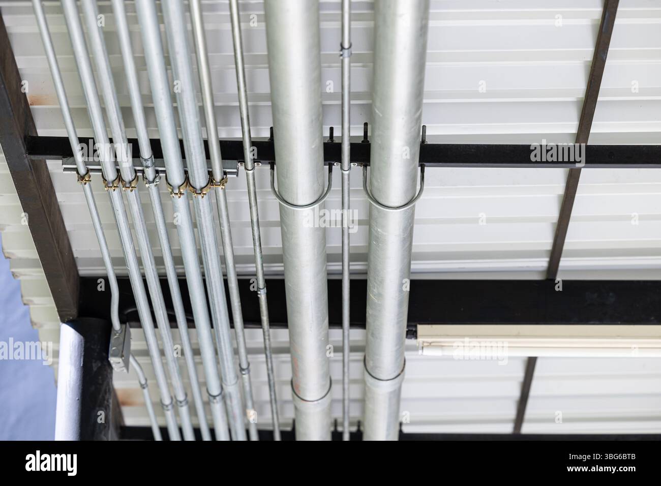 Conduit metal power pipe on ceiling. Conduits Electrical power line ...